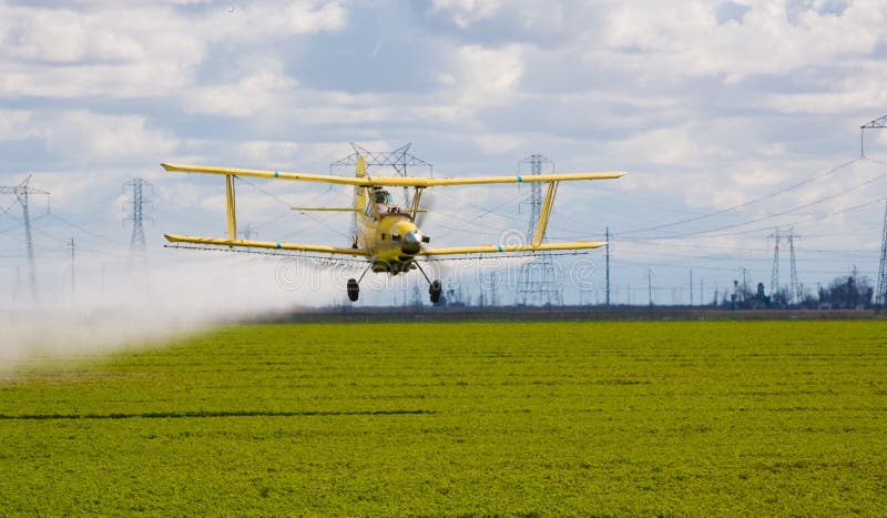 Biplane Crop Duster Spraying a Farm Field. Stock Image - Image of ...