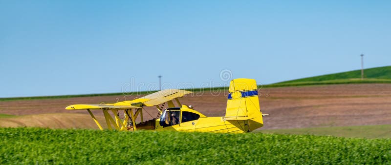 Crop Duster Dips Below Farm Fields As it Sprays Stock Photo - Image of ...