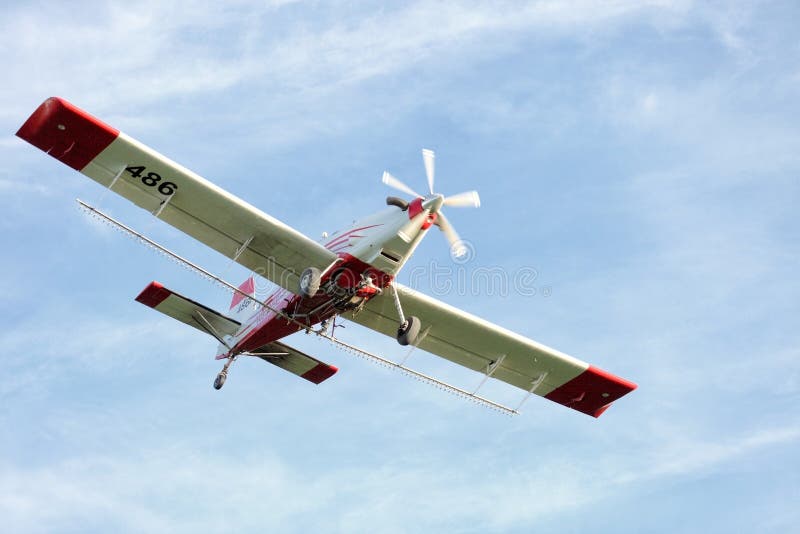 A Crop Dusting Aircraft Comes in Low for a Spraying Pass Early in the ...