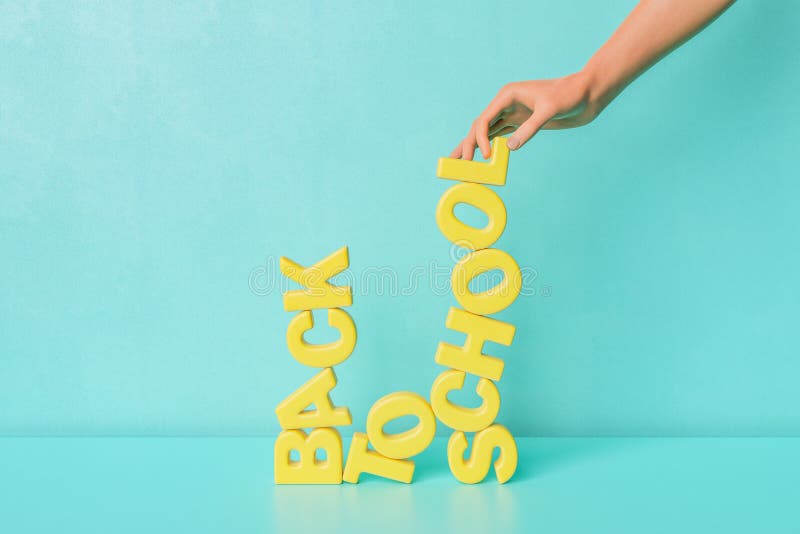 Crop Person Stacking Yellow Letters in Blue Studio Stock Illustration ...