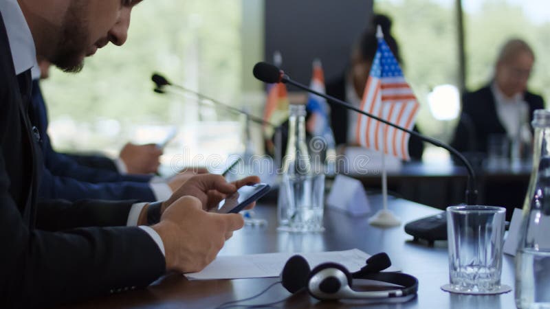 Summit Member Using Phone at Table Stock Photo - Image of headset ...
