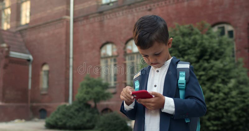 Crop View of Boy Tapping and Looking at Smartphone Screen while Waiting ...