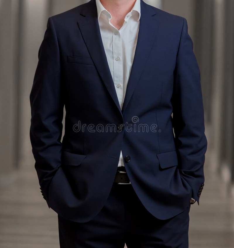 Cropped Head Man Standing in a Smart Suit with Hands in Pockets ... Cropped Head Man Standing in a Smart Suit with Hands in Pockets ...
