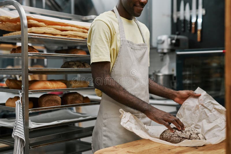 Bakery Worker Wrapping Bread Stock Photo - Image of making, baked ...