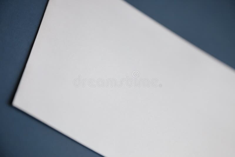 Cropped Image of a Blank White Paper on Dark Blue Surface Stock Photo ...