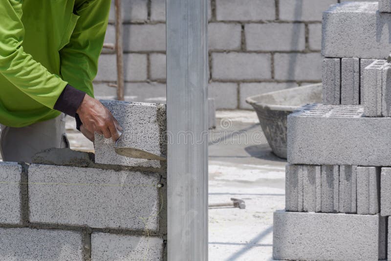 Bricklayer Making Interior Concrete Block Wall Inside of House ...