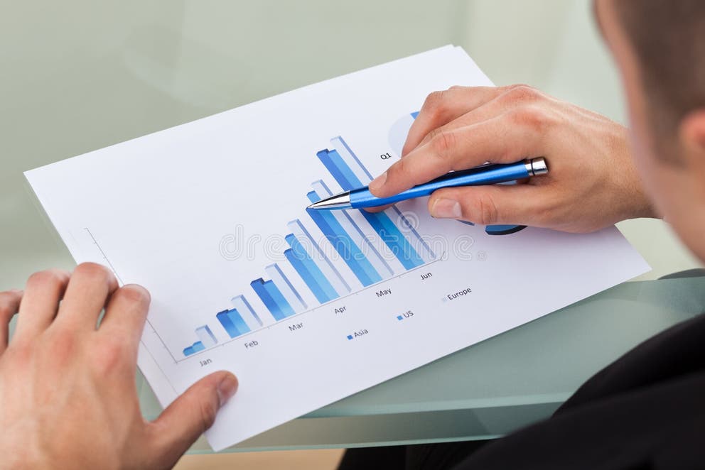 Cropped Image of Businessman Analyzing Bar Chart with Pen Stock Photo ...