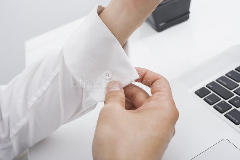 Cropped Image of Businessman Buttoning His Cuff in Office Stock Photo ...
