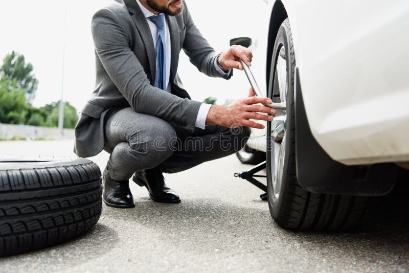 Businessman Changing A Tire Stock Photo - Image of change, driver: 3426954