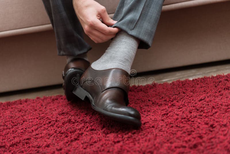 Cropped Image of Businessman Fixing Trousers while Sitting Stock Photo ... Cropped Image of Businessman Fixing Trousers while Sitting Stock Photo ...