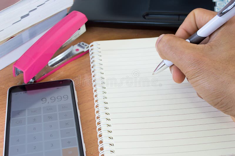 Cropped Image of Businessman with Laptop Writing in Book Stock Photo ...
