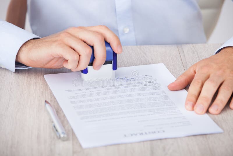 Cropped Image of Businessman Stamping Contract Paper Stock Image ...