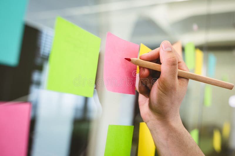Cropped Image of Businessman Writing on Sticky Notes Stock Image ...