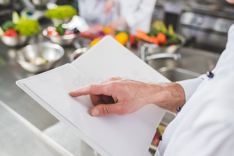 Cropped Image of Chef Reading Recipe Book Stock Image - Image of ...