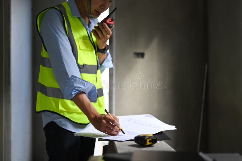Cropped Image of Civil Engineer Communicating with Walkie Talkie and ...