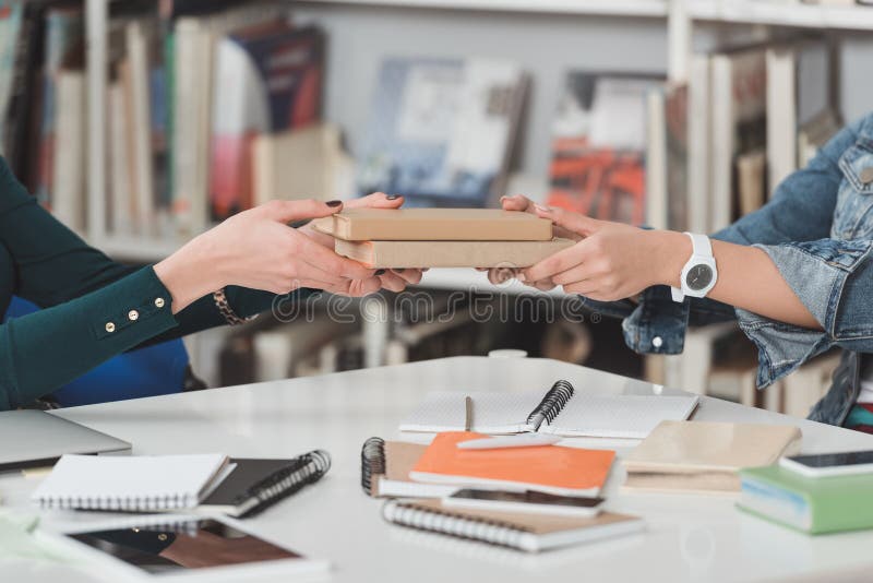 Cropped Image of Girl Giving Books To Student Stock Image - Image of ...