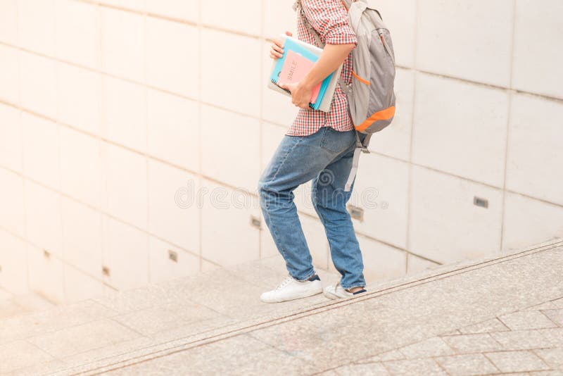 Cropped Image of Male Student Running with Book in Hands Stock Photo ...