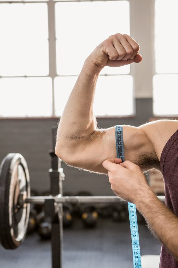 Man Measuring His Biceps with a Tape Measure Stock Photo - Image of ...