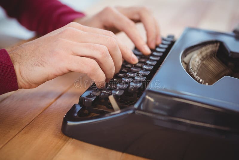 Cropped Image of Man Typing on Typewriter at Desk Stock Photo - Image ...