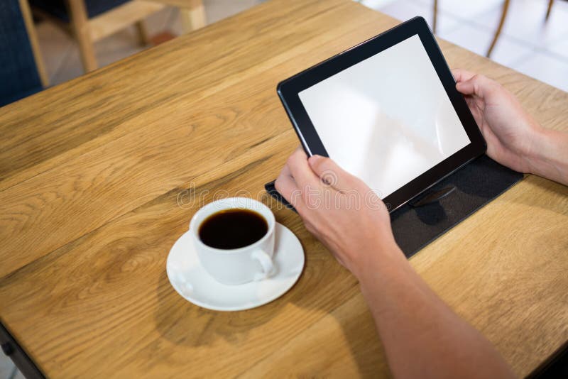 Cropped Image of Man Using Digital Tablet in Cafe Stock Image - Image ...