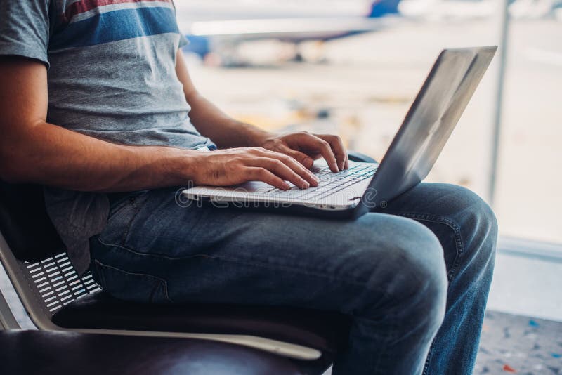 Cropped Image of a Man Using Laptop To Write Emails in Airport Terminal ...