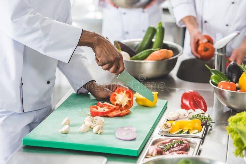 Cropped Image of Multicultural Chefs Cutting and Washing Vegetables ...