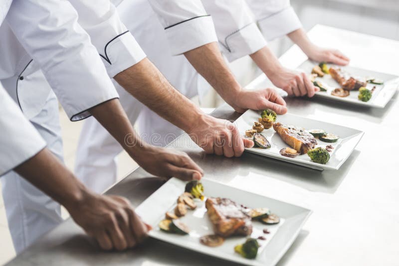 Cropped Image of Multicultural Chefs with Plates with Steaks at ...