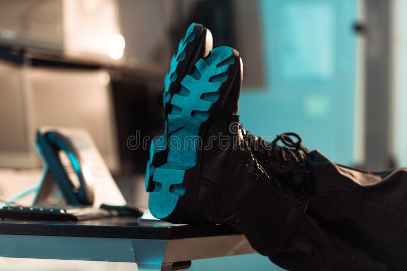 Cropped Image of Prison Guard Sitting with Legs Stock Photo - Image of ...