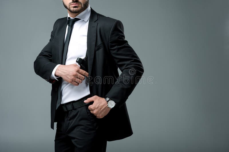 Cropped Image of Security Guard in Suit Taking Gun Stock Photo - Image ...