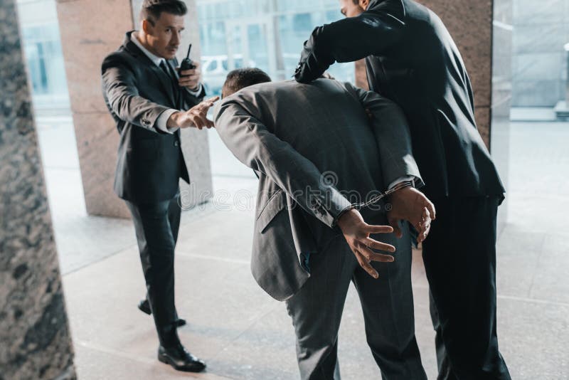 Cropped Image of Security Guards Arresting Offender and Talking Stock ...