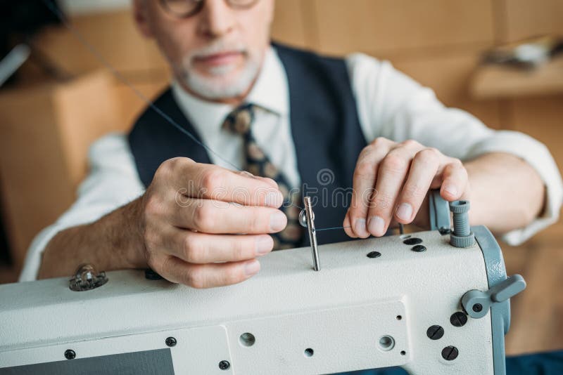 Cropped Image of Senior Tailor Threading Needle of Sewing Machine Stock ...