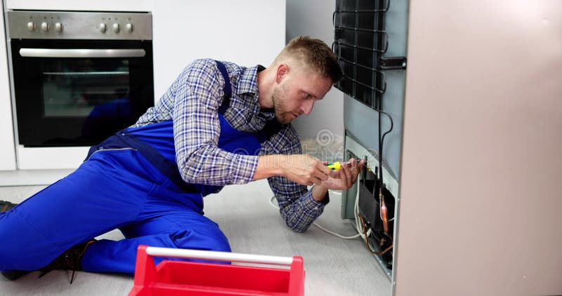 Cropped Image of Serviceman Working on Fridge with Screwdriver Stock ...