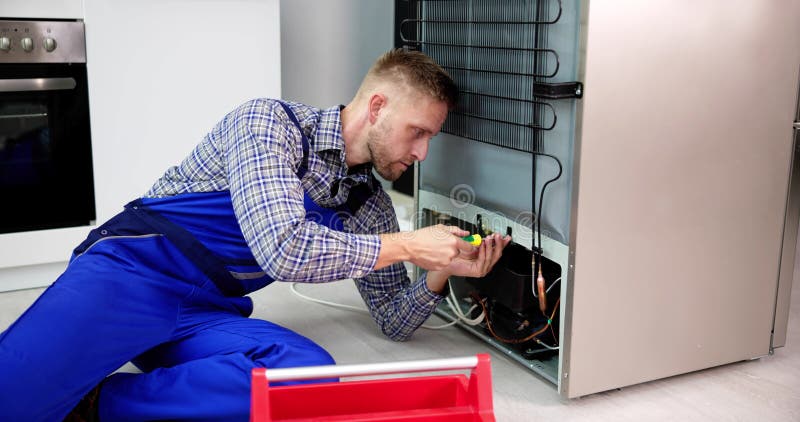 Cropped Image of Serviceman Working on Fridge with Screwdriver Stock ...
