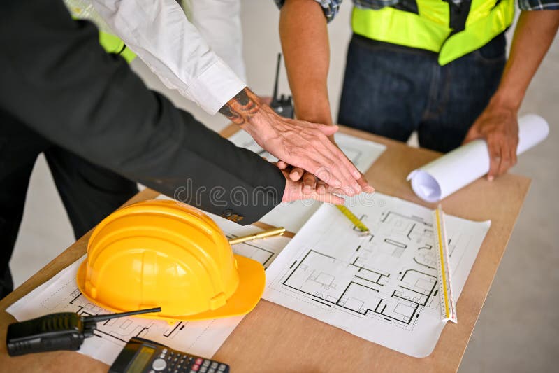Cropped Image of a Team of Construction Workers and a Businessman ...