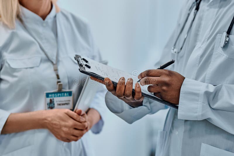 Cropped Image of Two Doctors Writing Information on Forms Stock Image ...