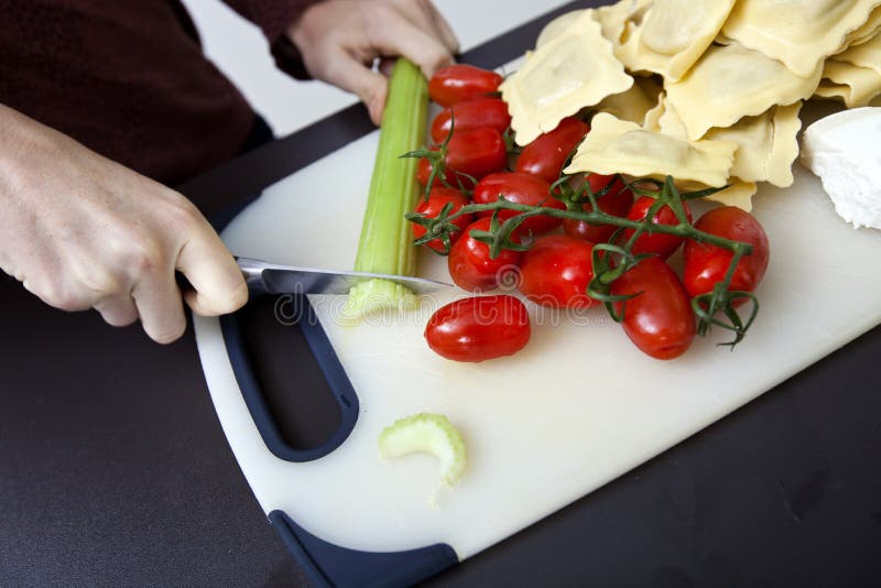 Cropped Image of Woman Chopping Cucumber at Kitchen Counter Stock Photo ...