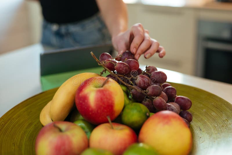 Cropped Image of Woman Eating Fruits on Kitchen Stock Image - Image of ...