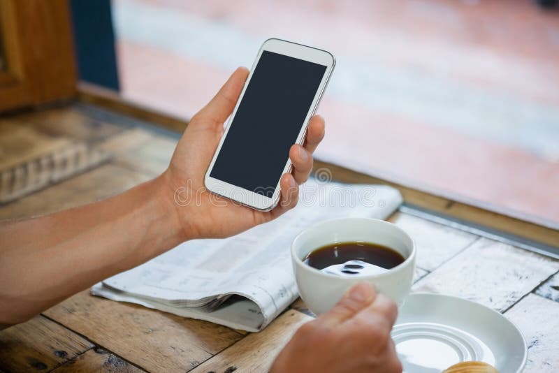 Cropped Image of Woman Holding Mobile Phone while Drinking Coffee Stock ...