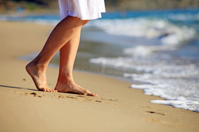 Woman Legs and Feet Walking on the Sand of the Beach Stock Image ...