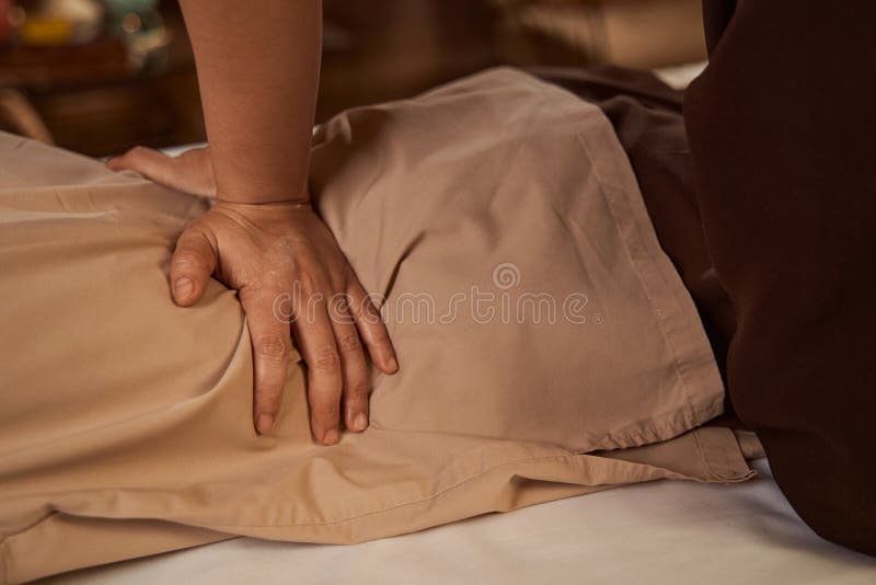 Practitioner Using Palm-pressing Technique during Thai Massage Session ...