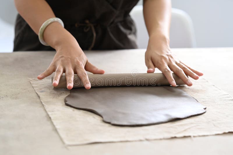 Cropped Shot of Ceramists Using Rolling Pin for Clay Mass, Making ...