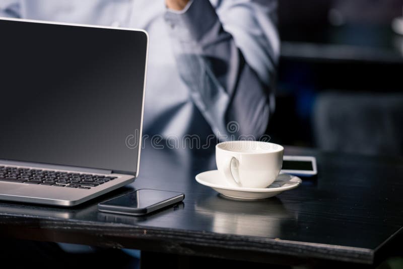 Cropped Shot of Laptop Computer, Smartphone and Cup of Coffee in Cafe ...