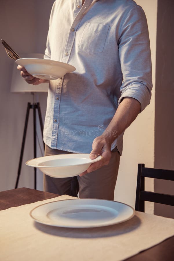 Cropped Shot of Man Serving Table with Plates for Romantic Dinner Stock ...