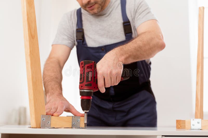 Cropped Shot of Professional Carpenter Using Drill Assembling Table ...