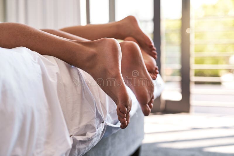 Resting Our Feet. Cropped Shot of an Unrecognizable Couples Bare Feet ...