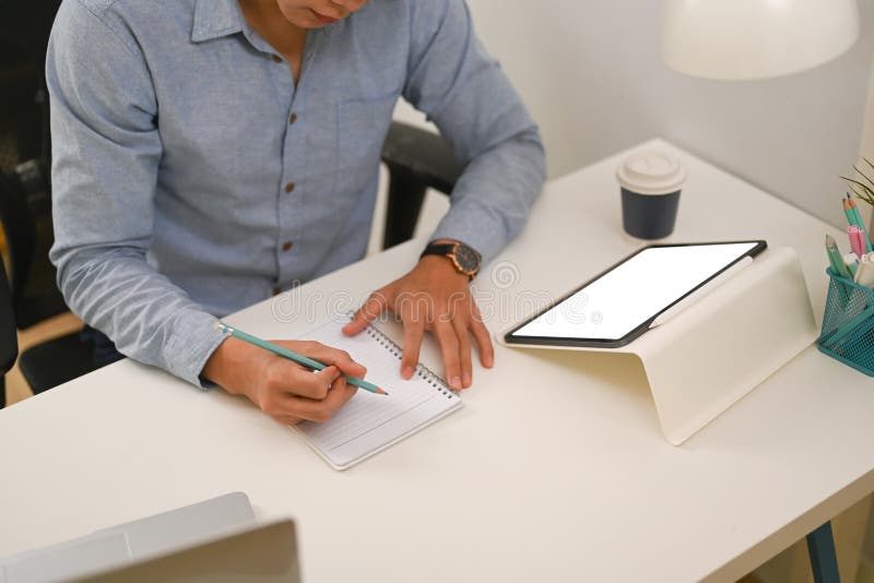 Cropped Young Man Working with Digital Table and Making Note on ...