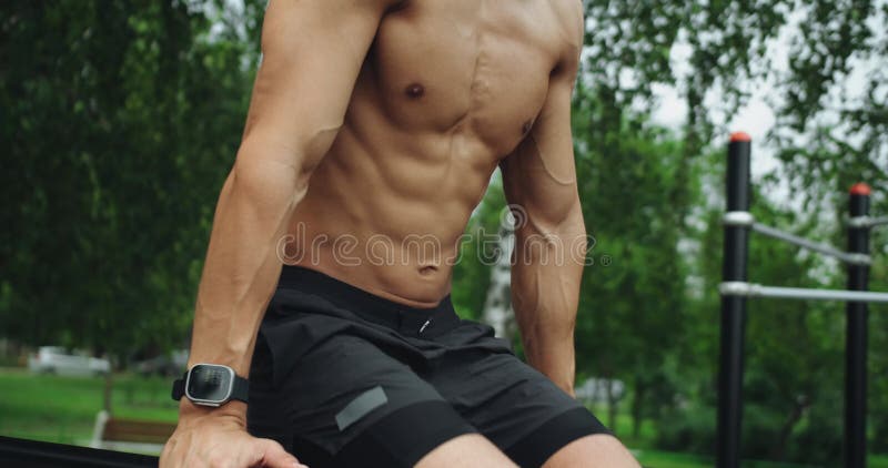 Athletic Man Training on Parallel Bar and Doing Abs Exercise Outdoors ...