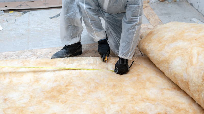 Man Cutting Rockwool Panel To Fit in Thermal Insulation Layer Stock ...