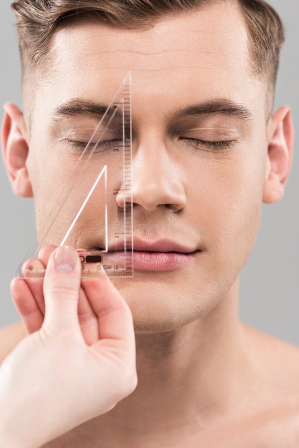 View of Plastic Surgeon Measuring Face with Ruler Isolated on Grey ...
