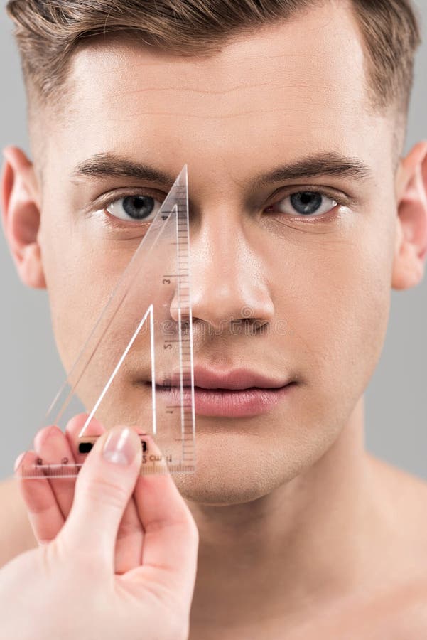 View of Plastic Surgeon Measuring Face with Ruler Isolated on Grey ...